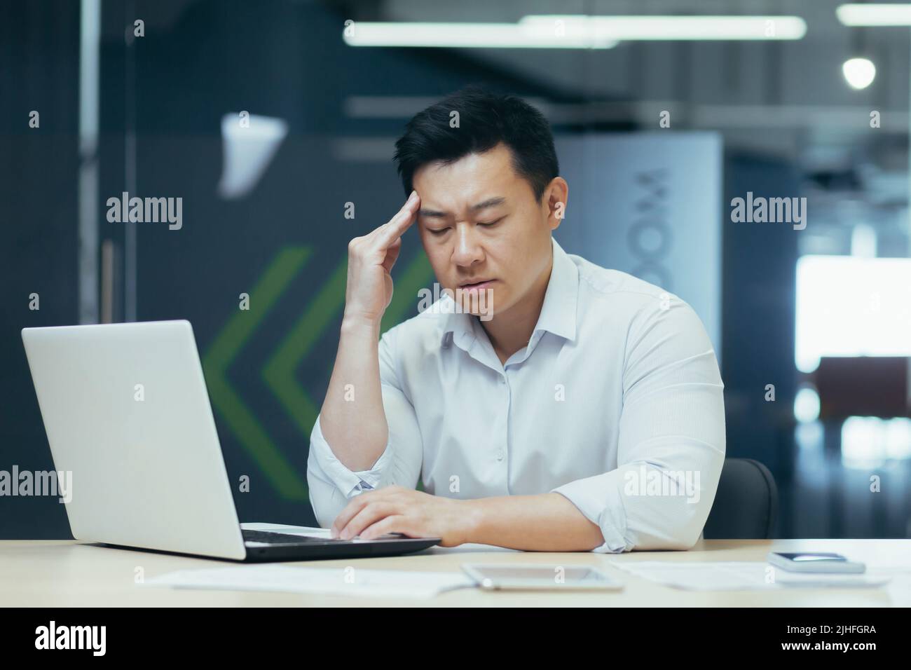 Depressed businessman, boss working in modern office, thinking asian ...