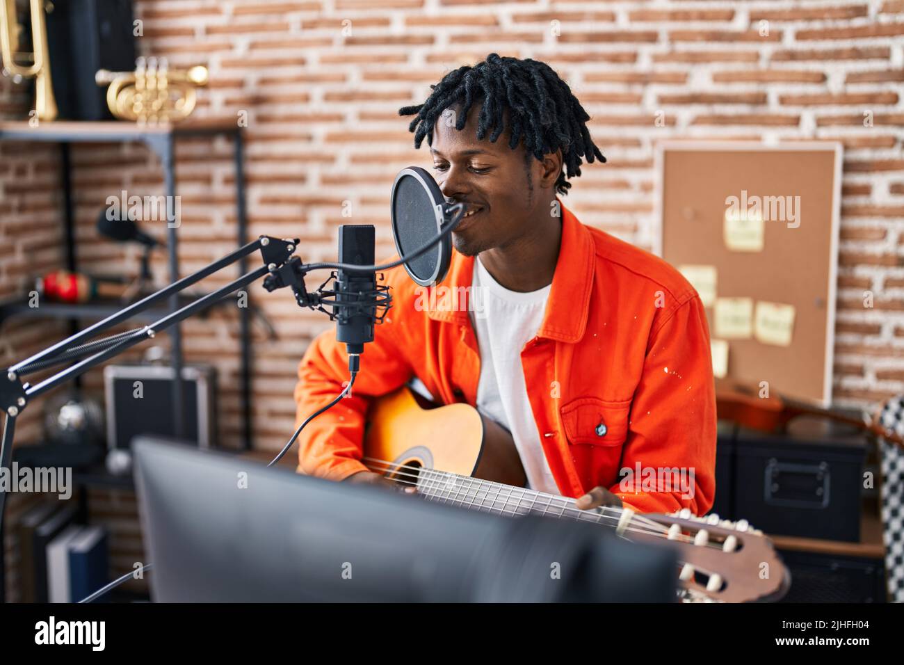African american man singing song playing classical guitar at music ...