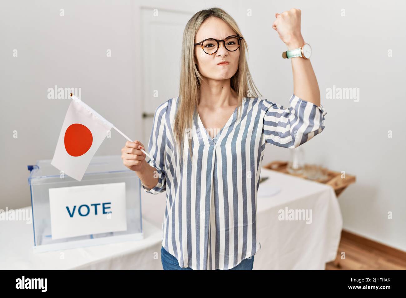 Asian young woman at political campaign election holding japan flag ...