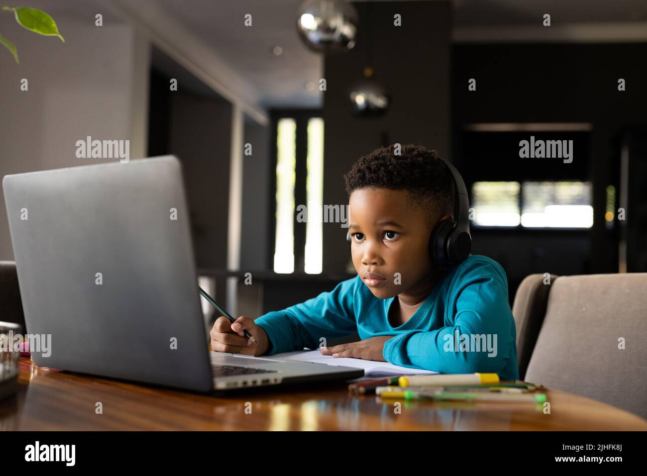 Image of african american boy learning and using laptop Stock Photo - Alamy