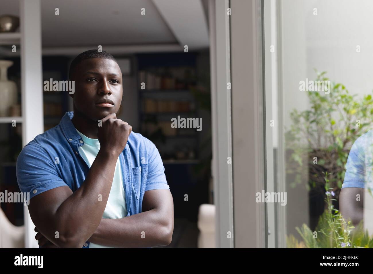 Image of thoughtful african american man looking outside window Stock ...
