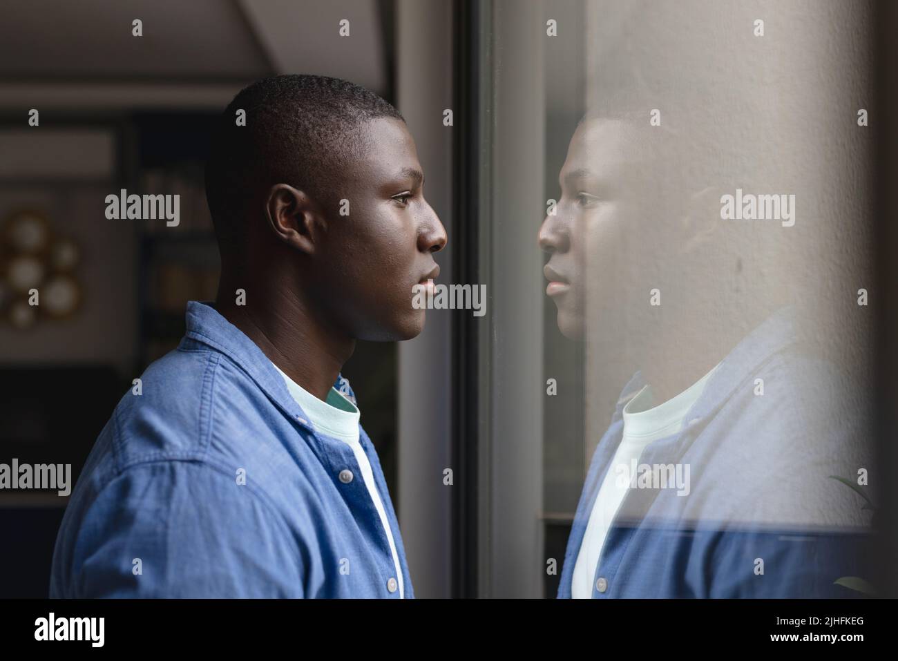 Image of thoughtful african american man looking outside window Stock ...