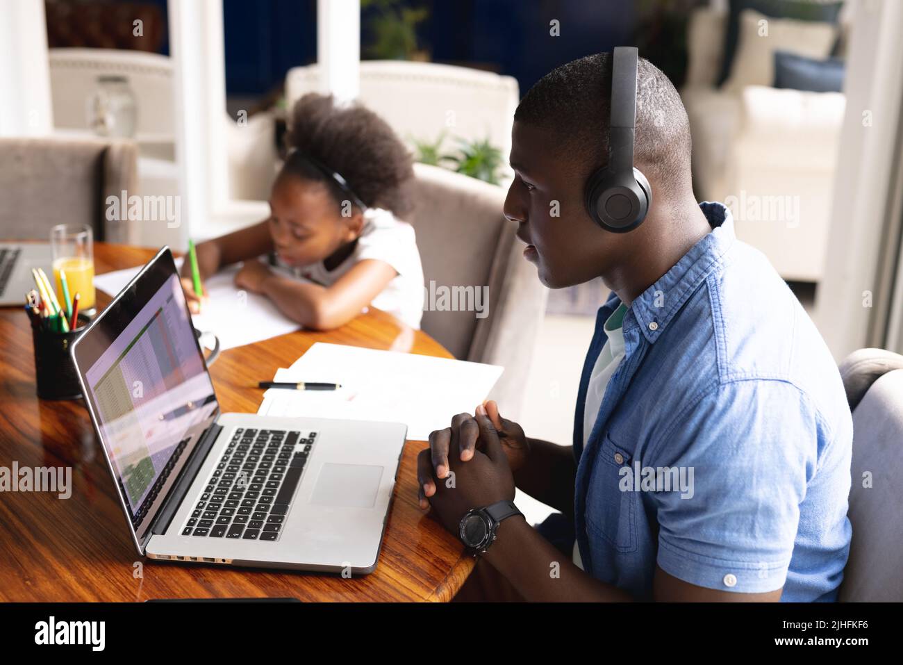 Happy african american father and daughter doing homework and working together Stock Photo - Alamy