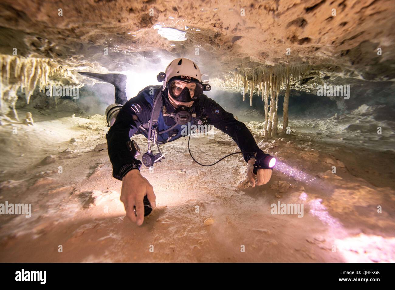 A diver navigates a tight space in the labyrinth of underwater caves ...