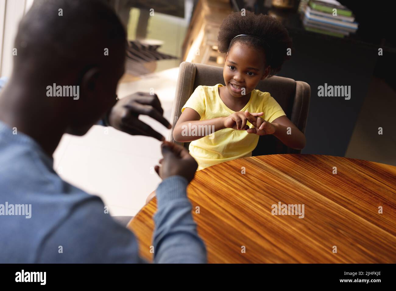 Image of happy african american father and daughter playing finger ...