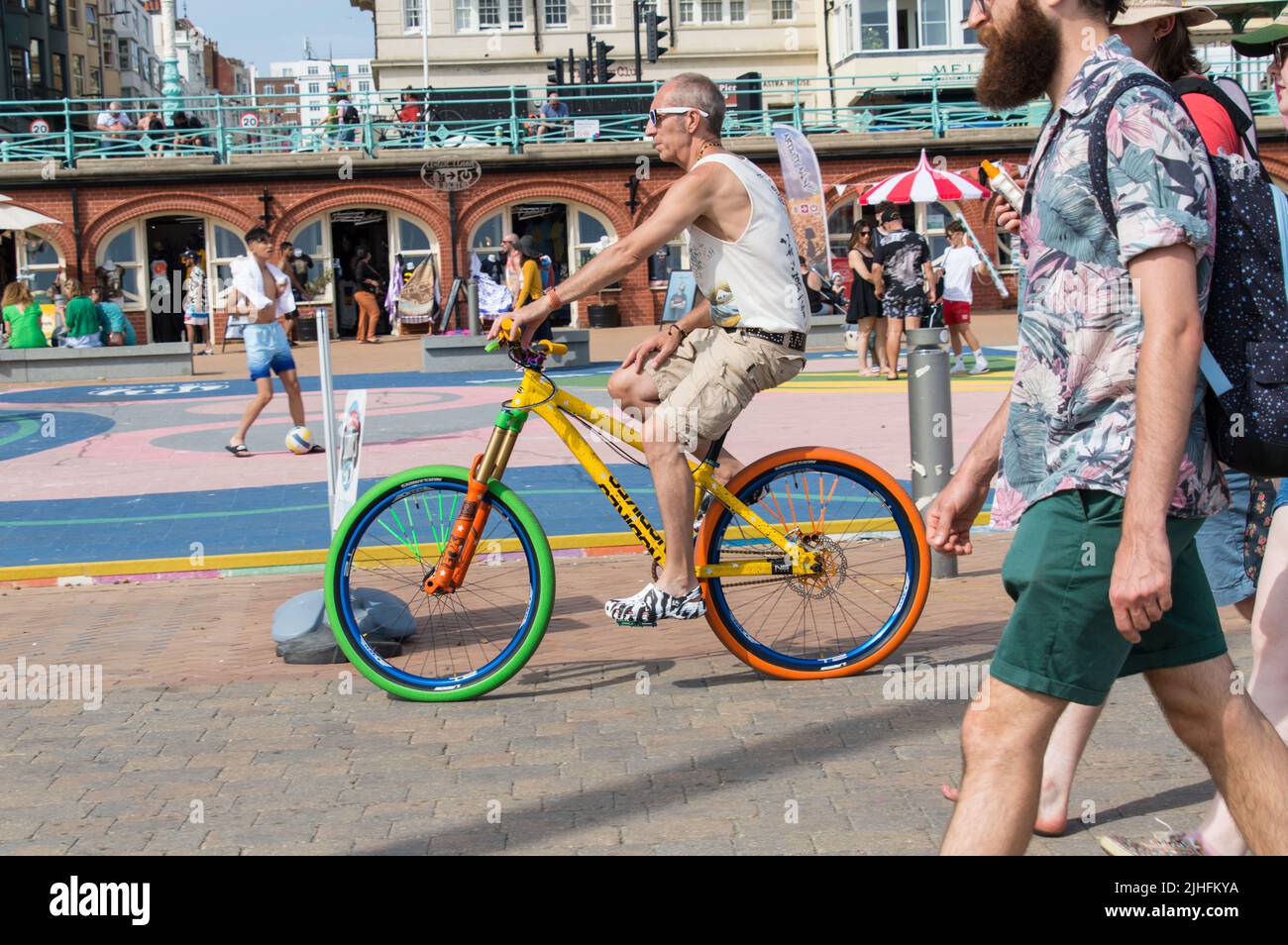 Multi colored bicycle ridden in promenade on Brighton beach Heatwave ...