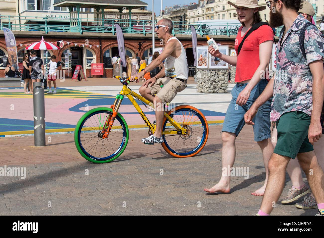 Multi colored bicycle ridden in promenade on Brighton beach Heatwave ...