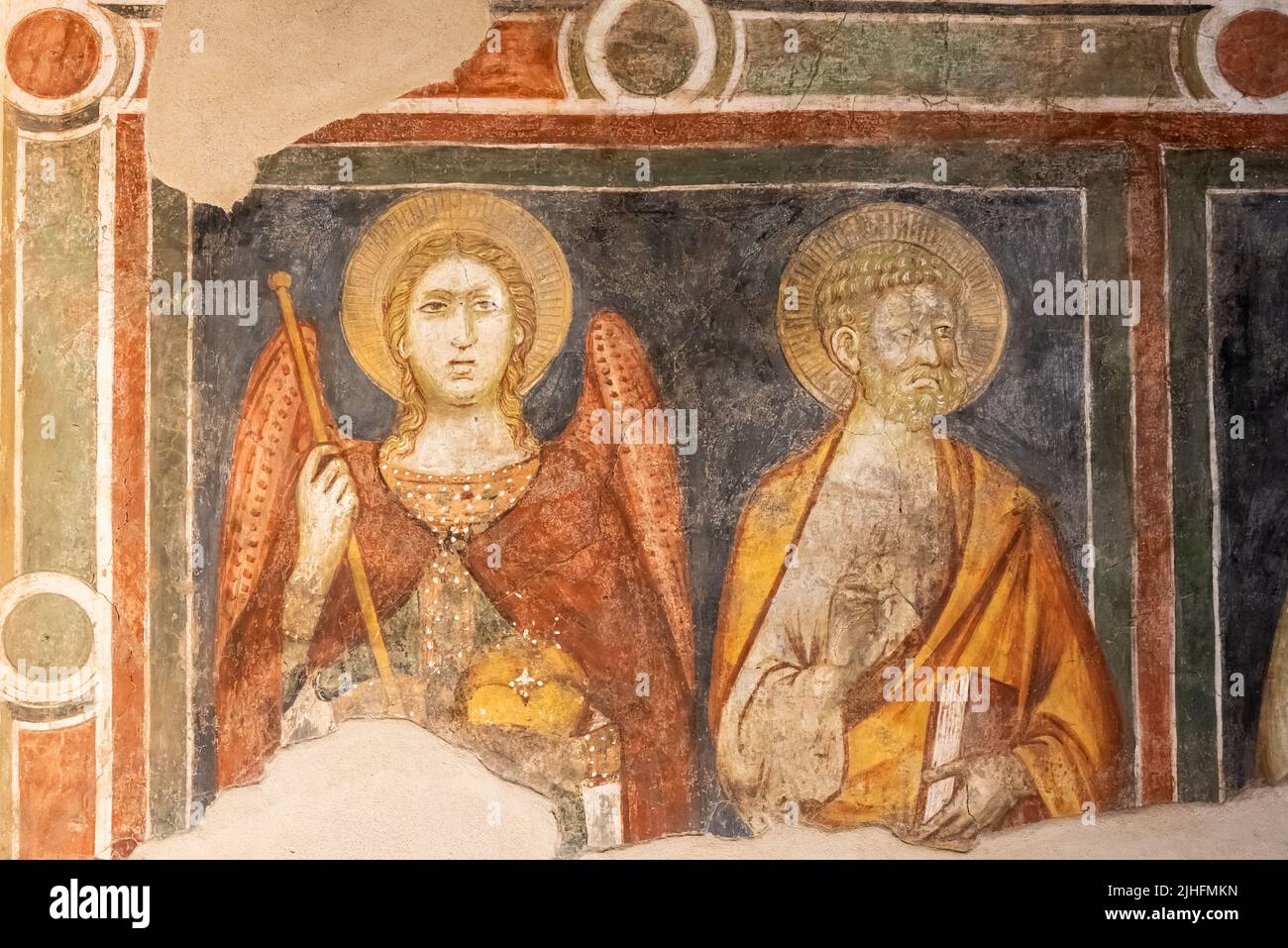 Medieval religious fresco in ruins showing an angel and a catholic male ...