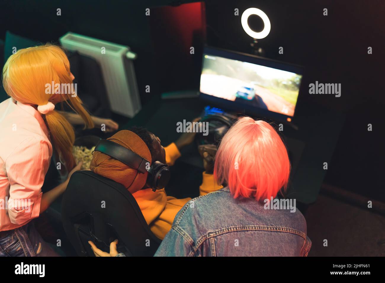 Back shot of a group of interracial female and male gamers cheering ...