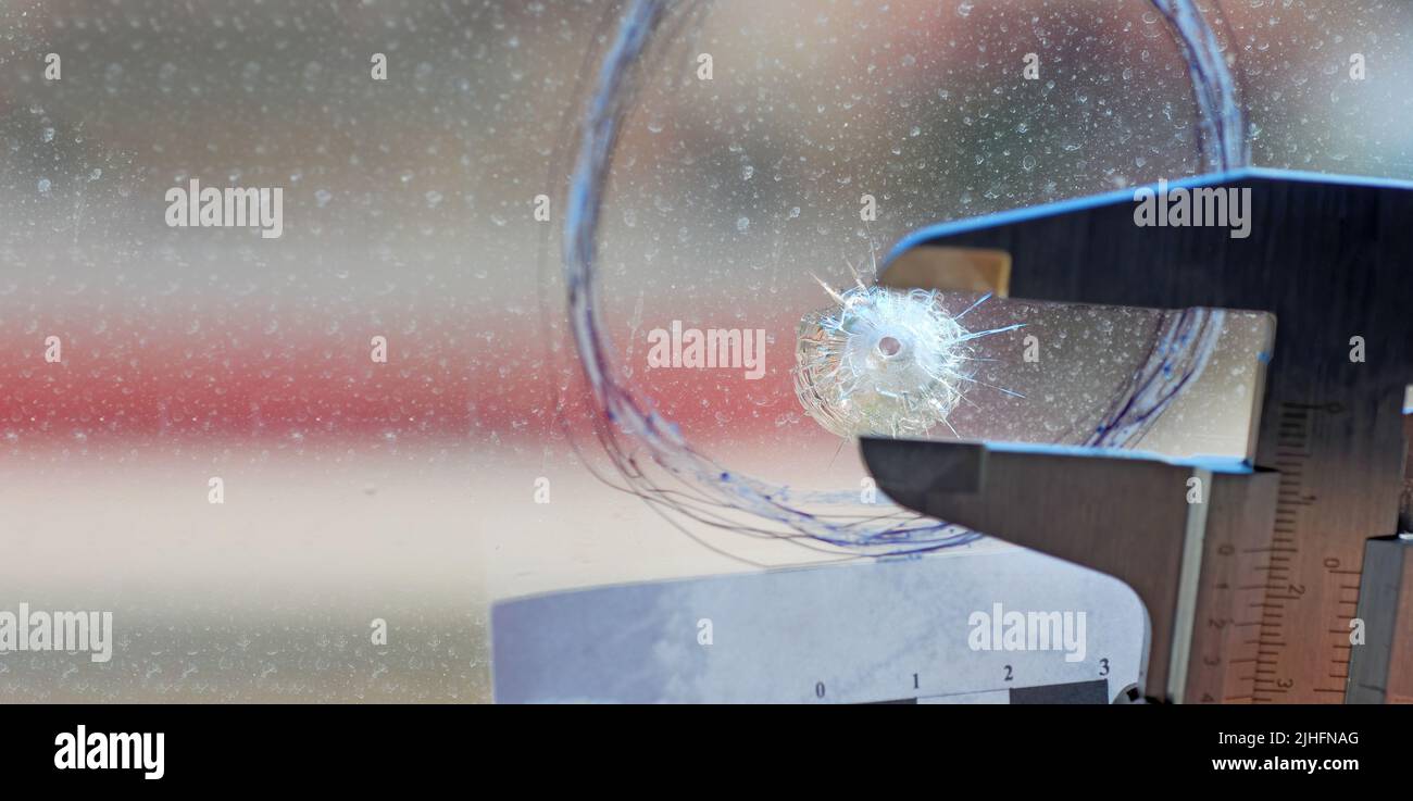 At the crime scene, the scientific police measure the caliber of the ...