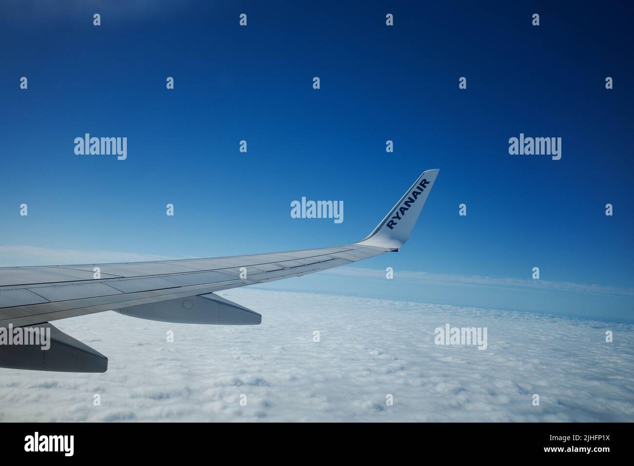 Boeing B737-800 of Ryanair in flight above deck of clouds during a ...