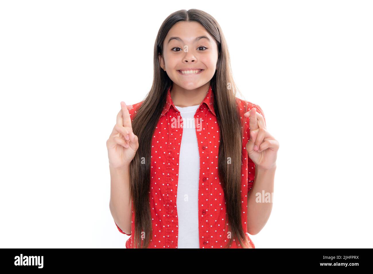 Joyful teenager girl fingers crossed, makes desirable wish, waits for ...