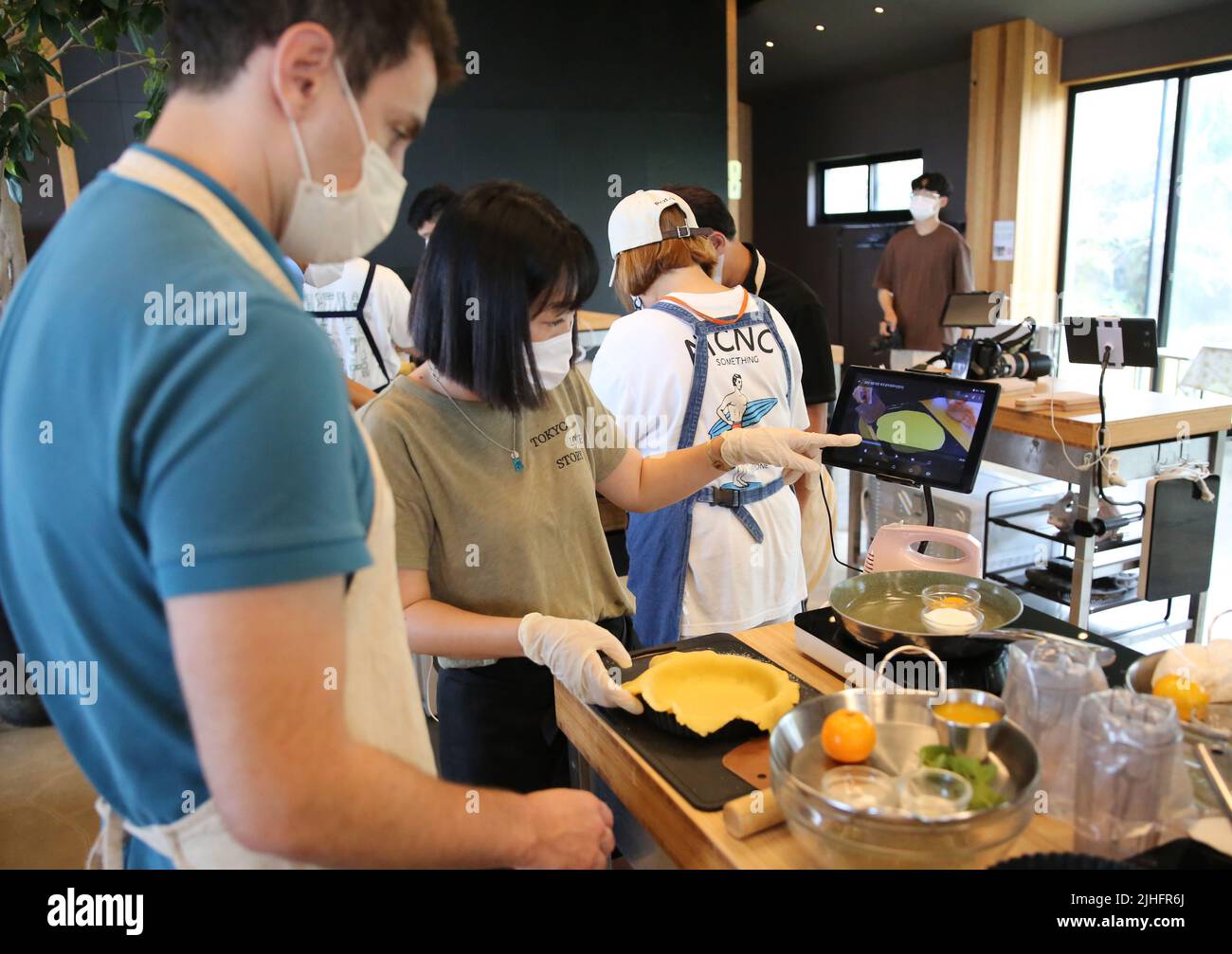 Jeju, South Korea. 15th July, 2022. Tourists experience baking at an on ...
