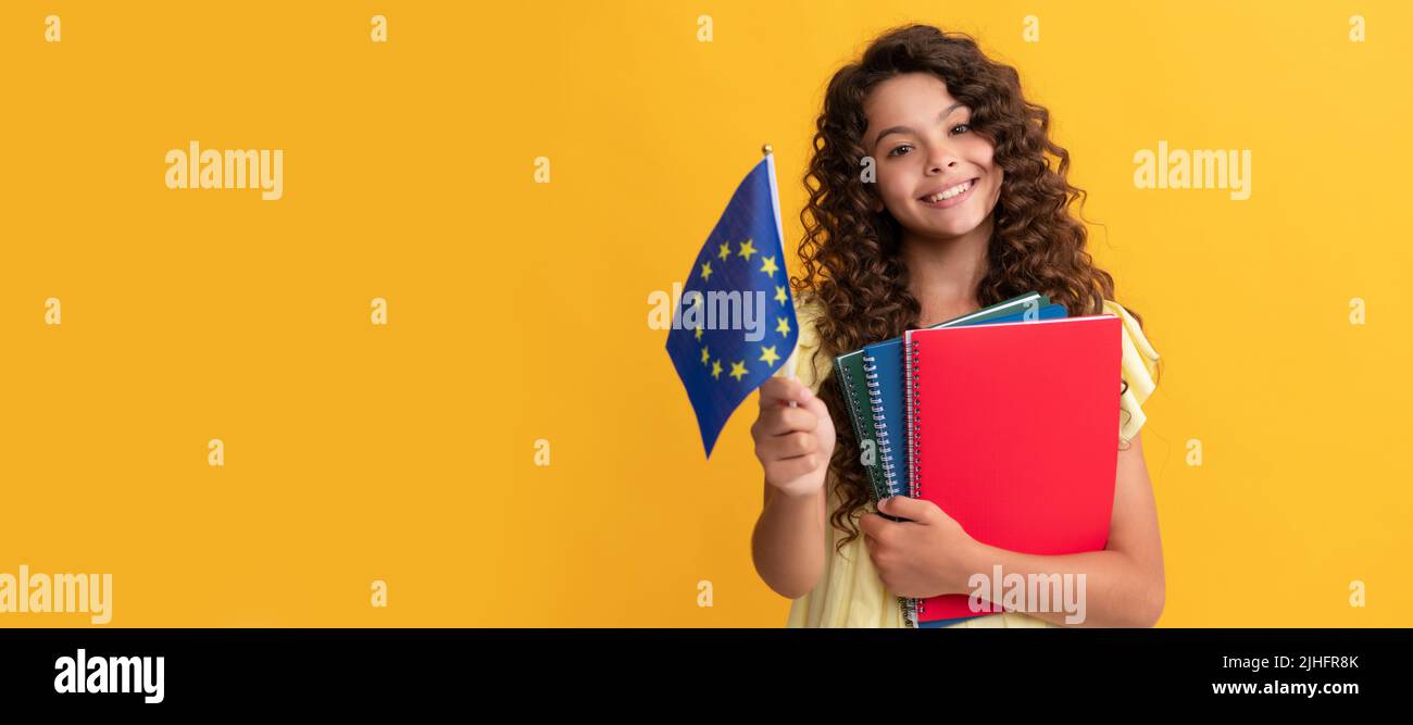 happy teen girl study with school workbooks hold european union flag ...