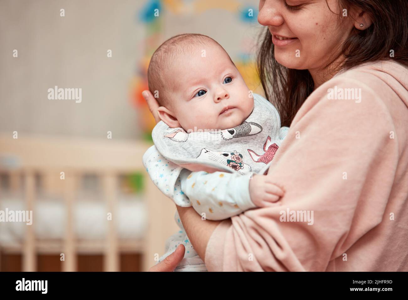 Young mother holding adorable newborn baby Stock Photo - Alamy