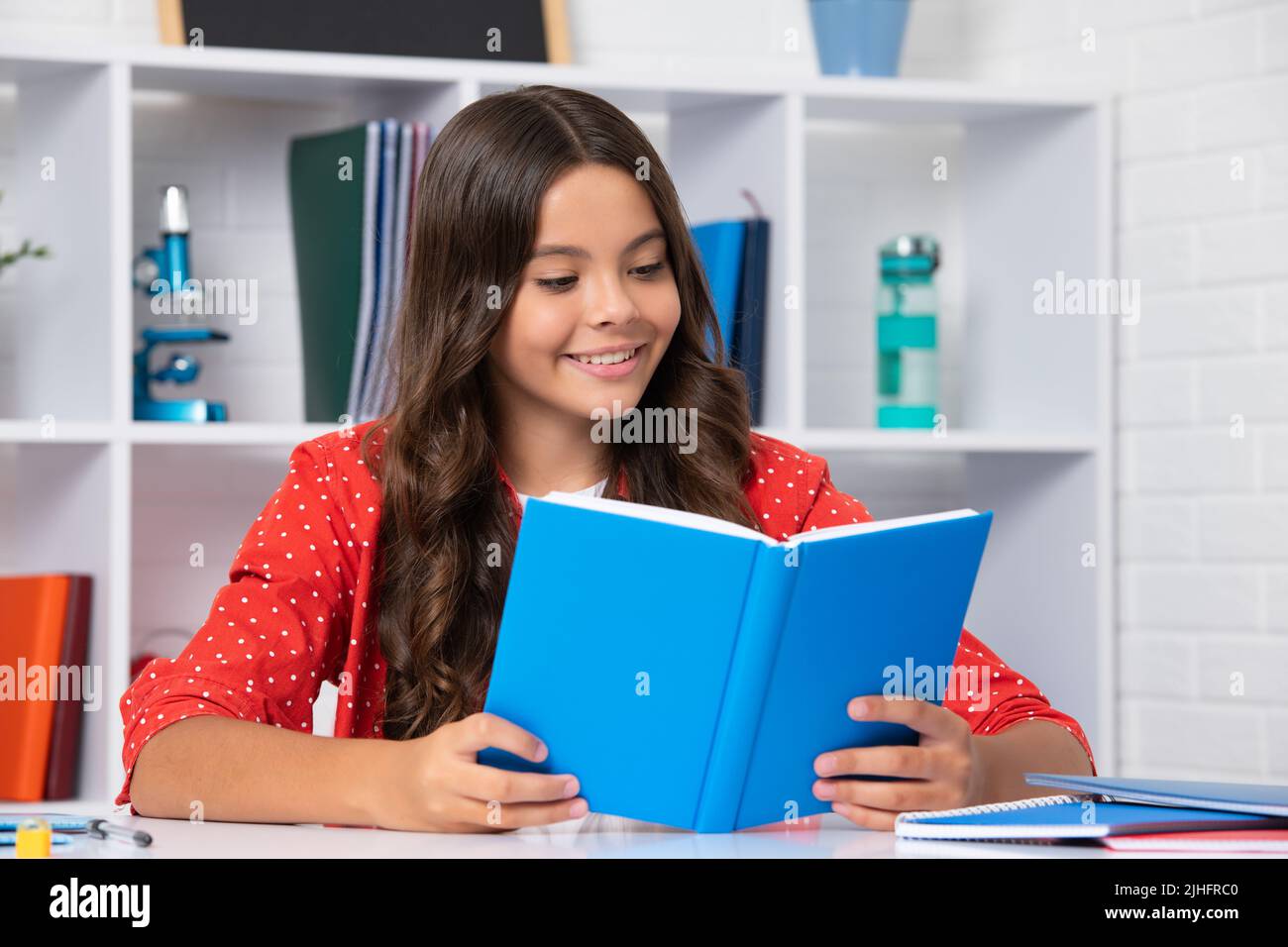 Back to school. Teenager school girl reading book ready to learn. Happy ...