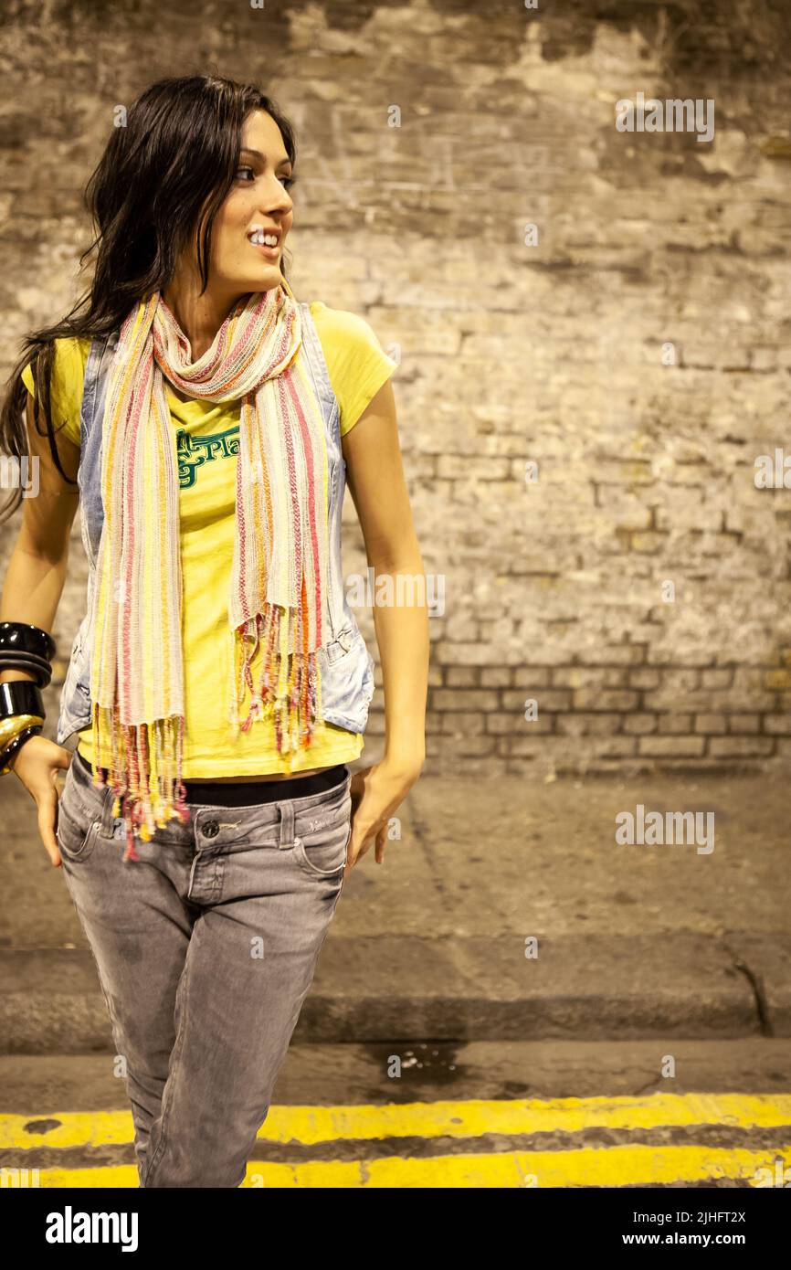 Urban Fashion. A beautiful young mixed race model in a relaxed mood ...