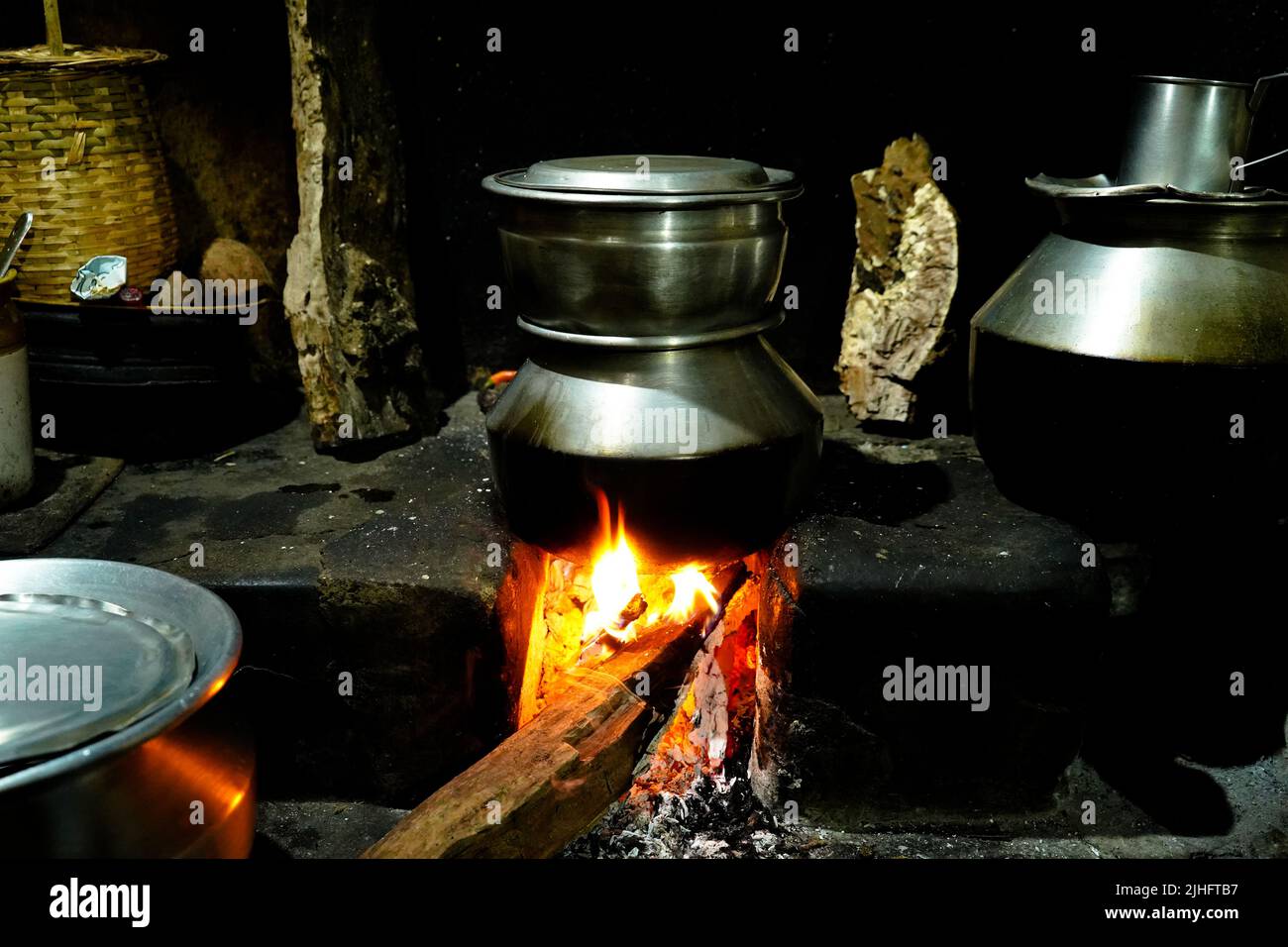 Food is prepared in an old village kitchen with firewood n Kerala with ...