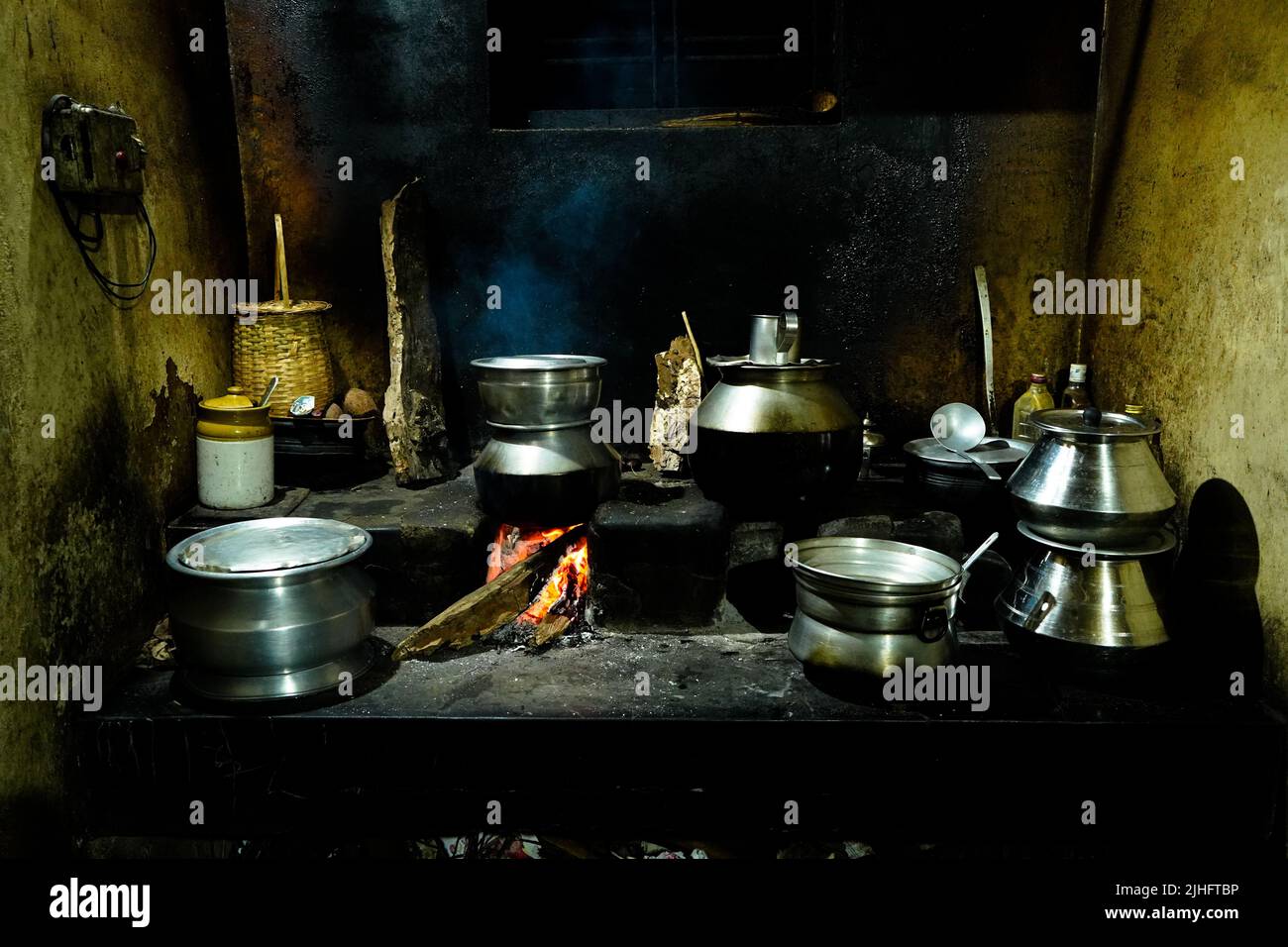 Food is prepared in an old village kitchen with firewood n Kerala with ...