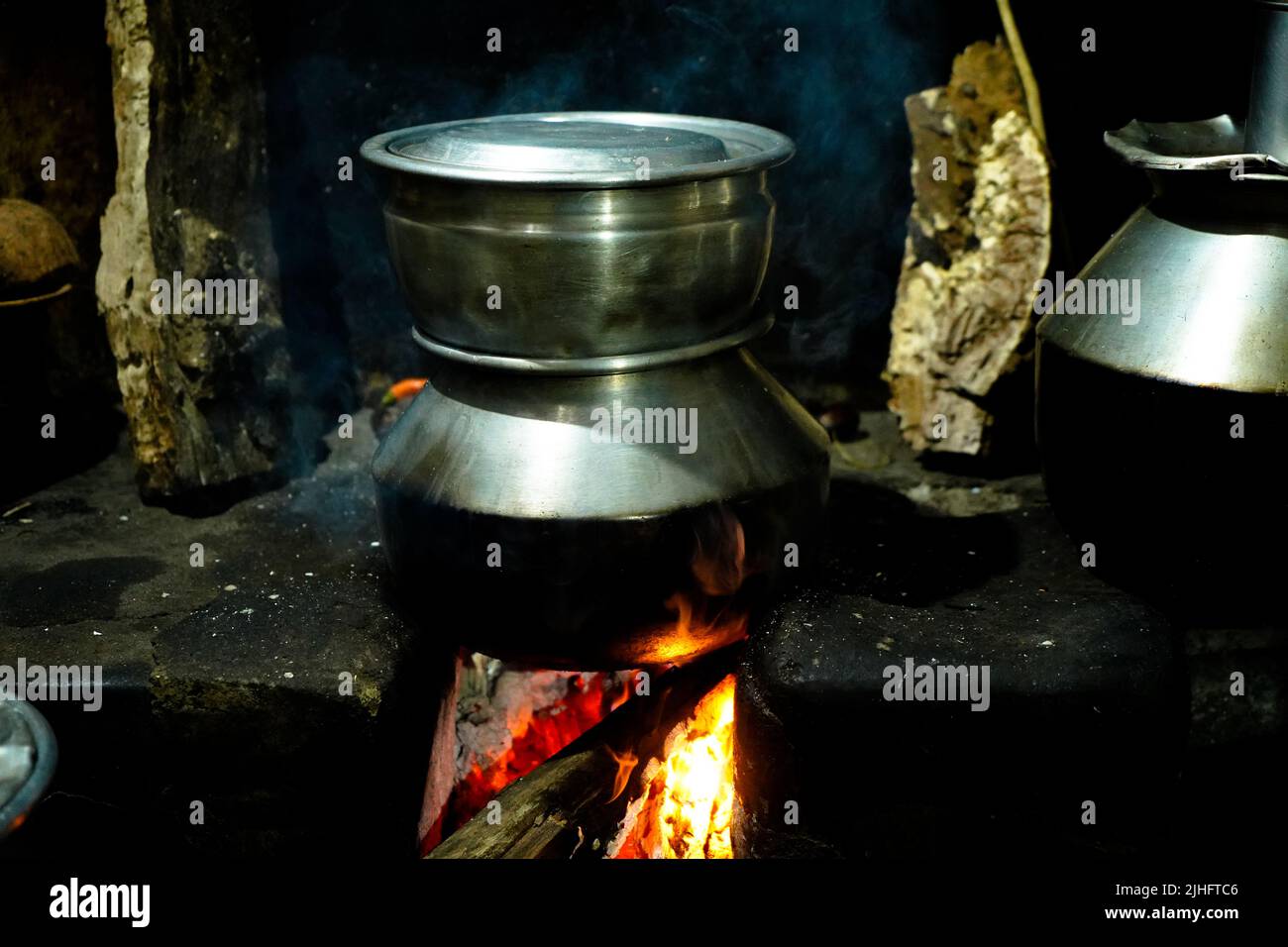 Food is prepared in an old village kitchen with firewood n Kerala with ...