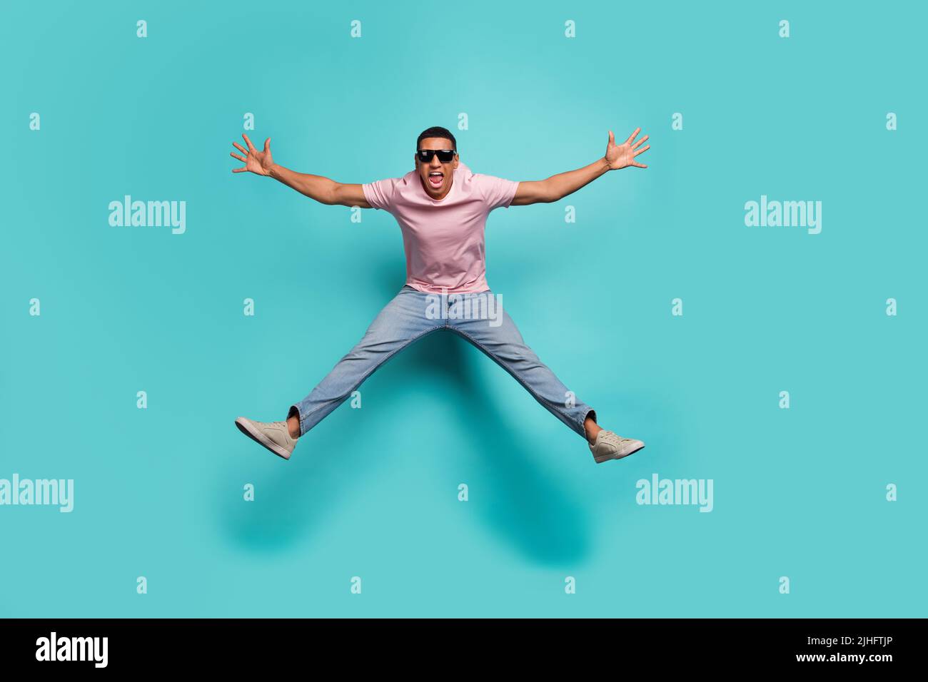 Full Length Photo Of Excited Pretty Man Dressed Pink T Shirt Jumping