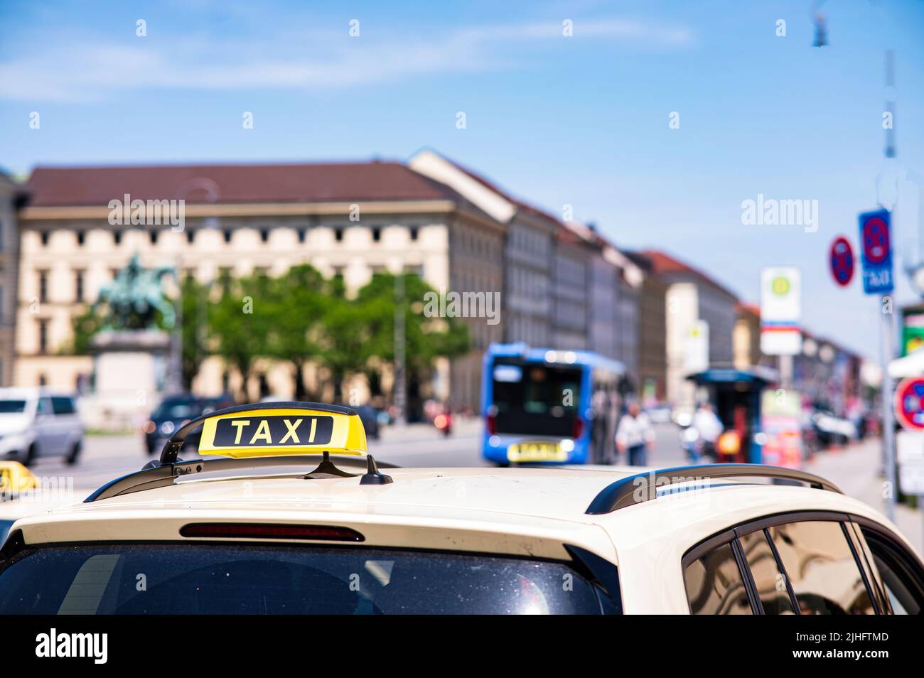 A close-up shot of a taxi sign on the car in the streets of Munich ...