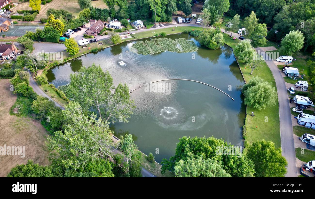 A bird's eye view of a pond surrounded by trees and parking areas Stock Photo - Alamy