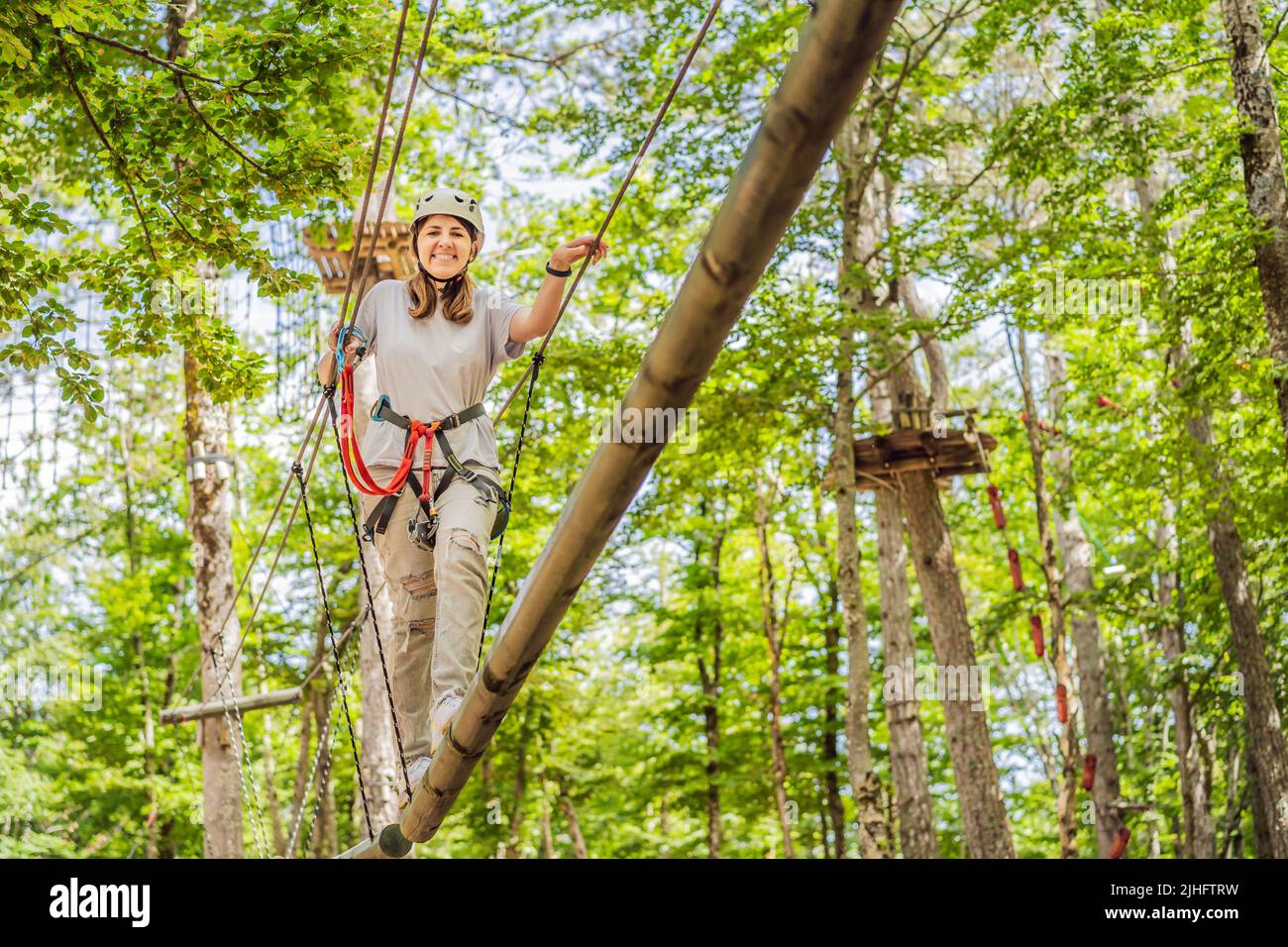 Happy women girl female gliding climbing in extreme road trolley ...