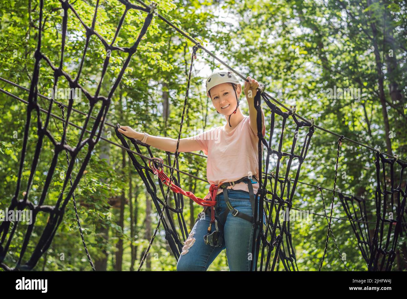 Happy women girl female gliding climbing in extreme road trolley ...