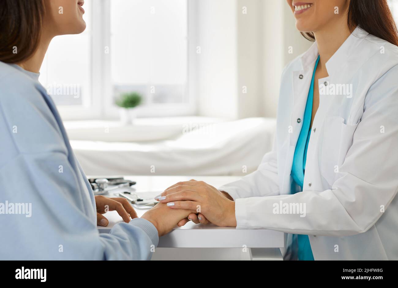 Female doctor who shows good medical care tells patient good news by ...