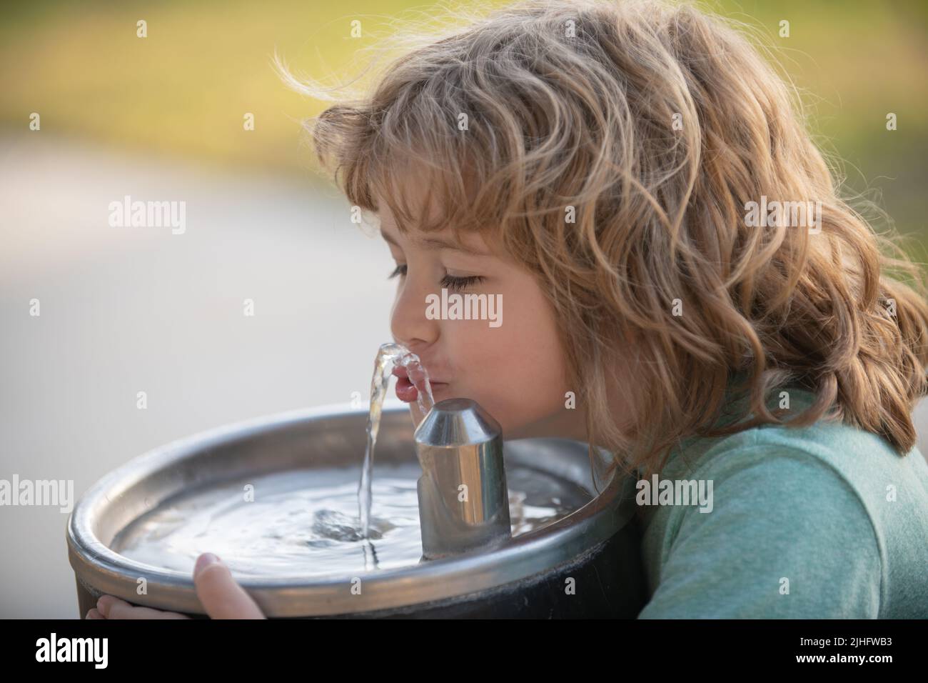 Child drinking water from outdoor water fountain outdoor Stock Photo ...