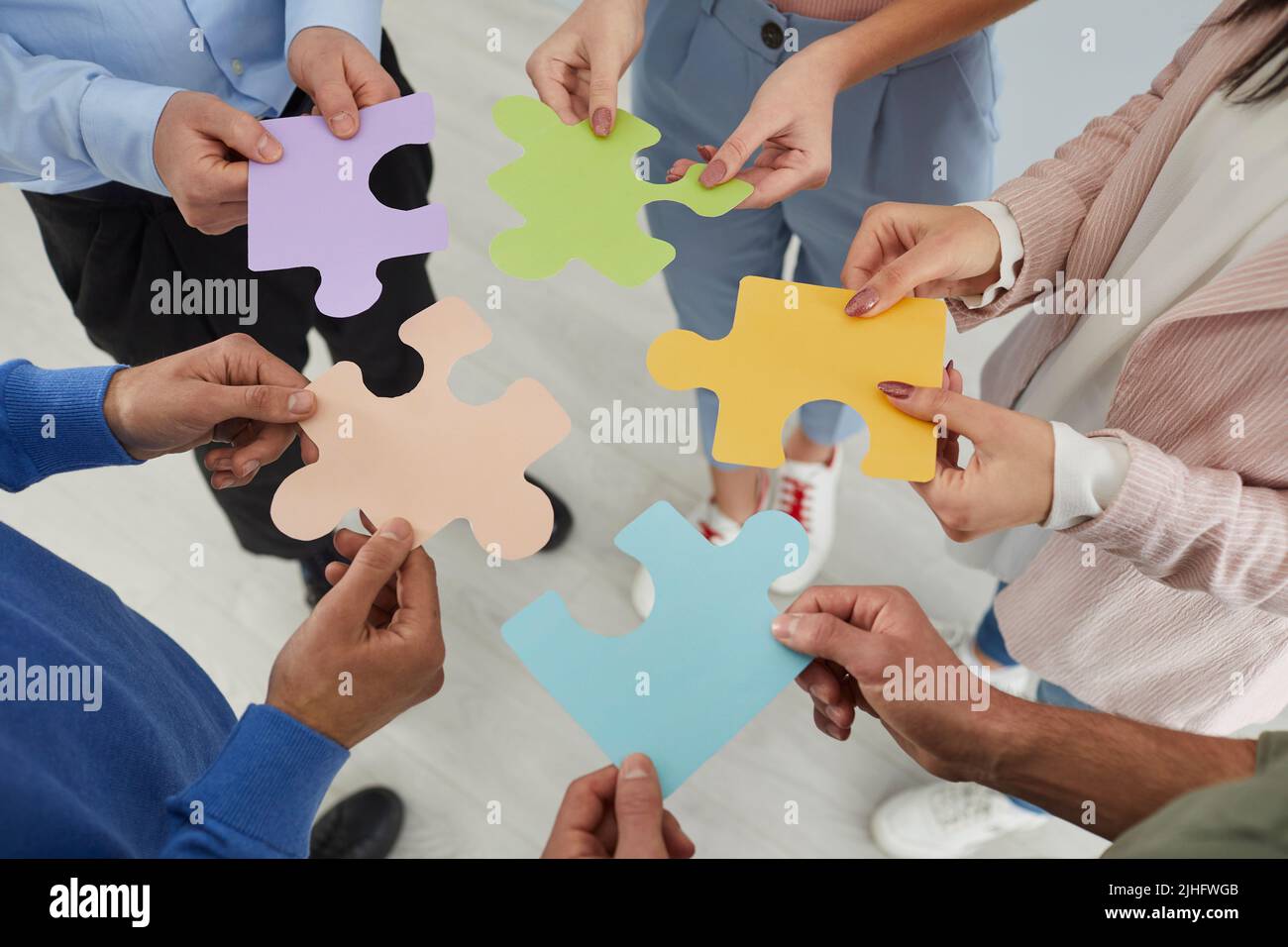 Team of creative business people with jigsaw puzzle trying to find ...
