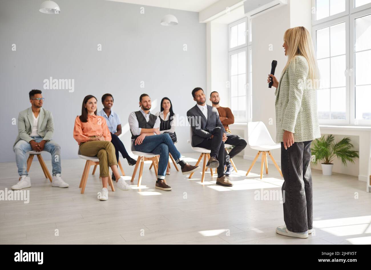 Woman coach lead meeting at group training Stock Photo - Alamy