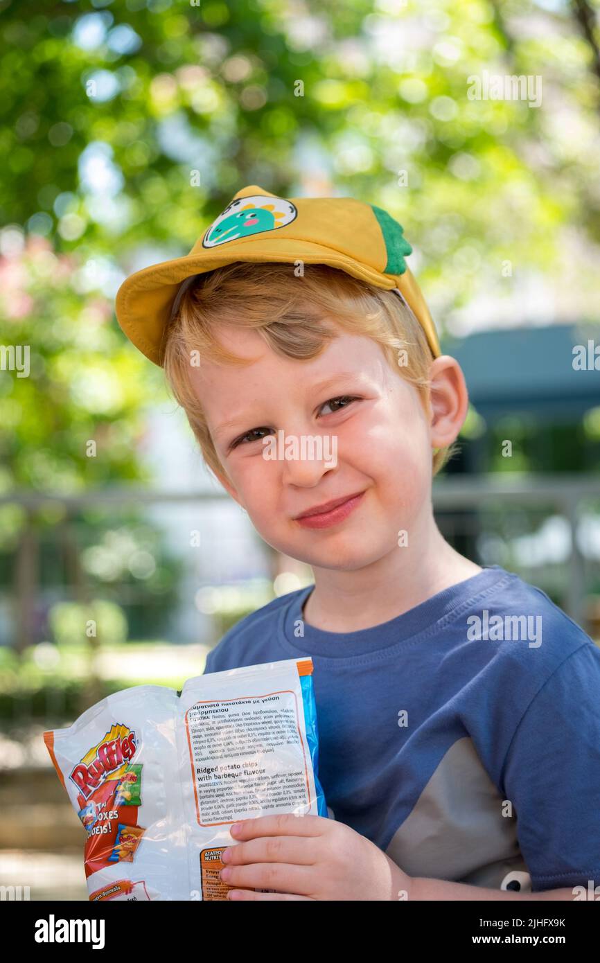 Boy eating chips hi-res stock photography and images - Alamy