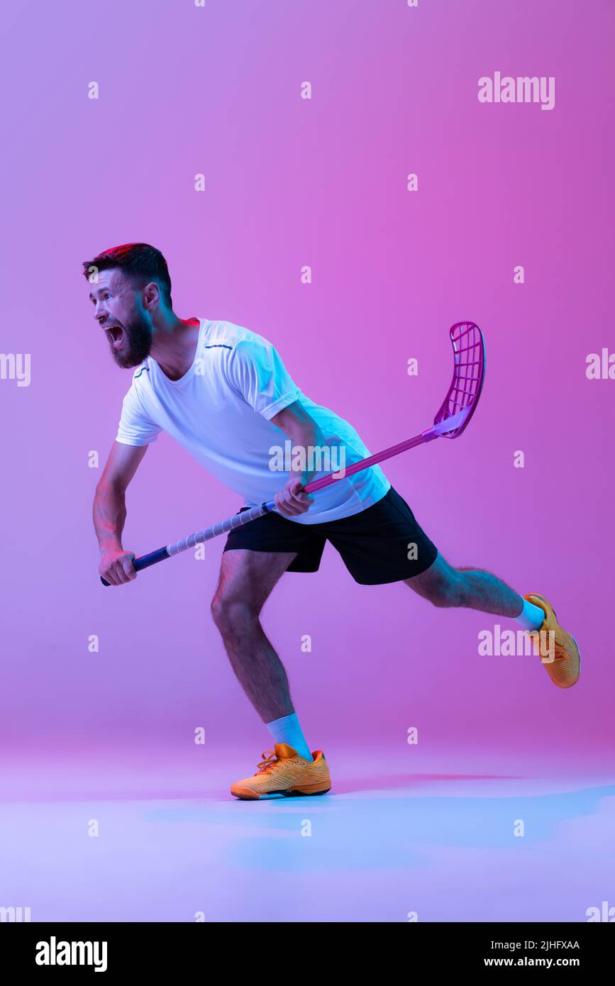 One sportive man, floorball player with floorball stick training ...