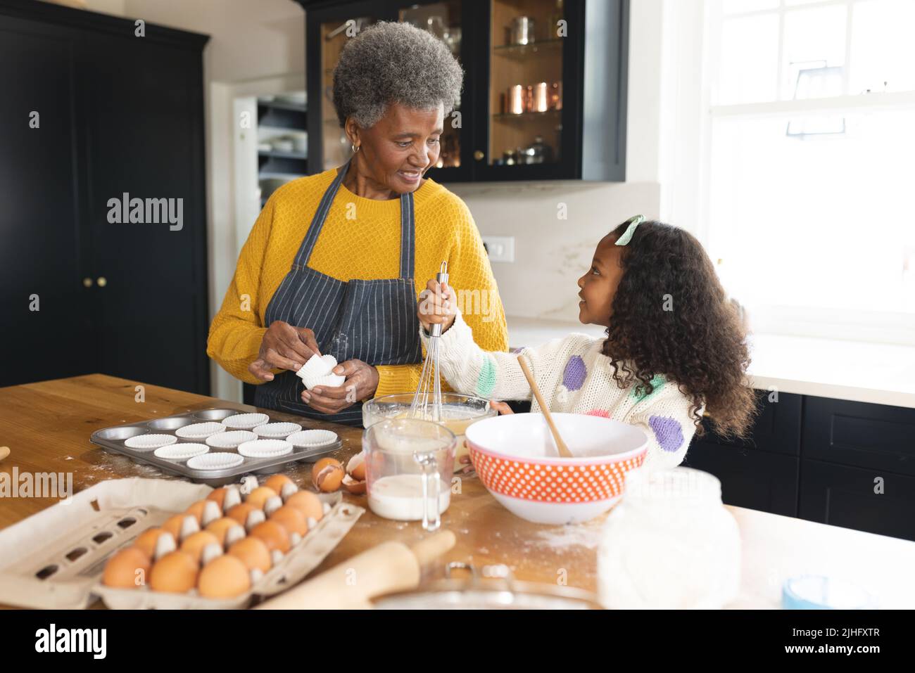 Image of happy african american grandmother and granddaughter baking in kitchen Stock Photo - Alamy