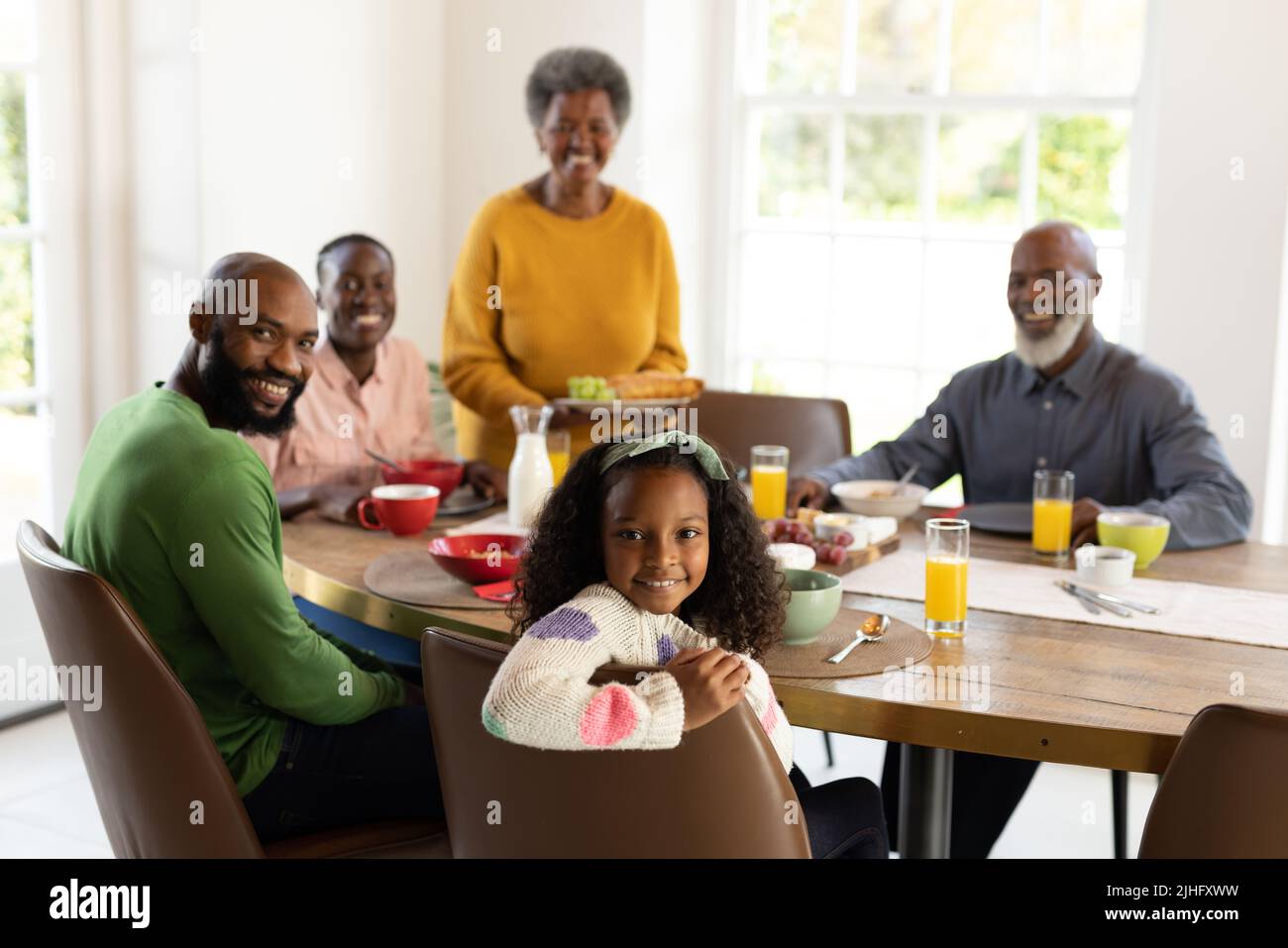Image of happy multi generation african american family eating ...
