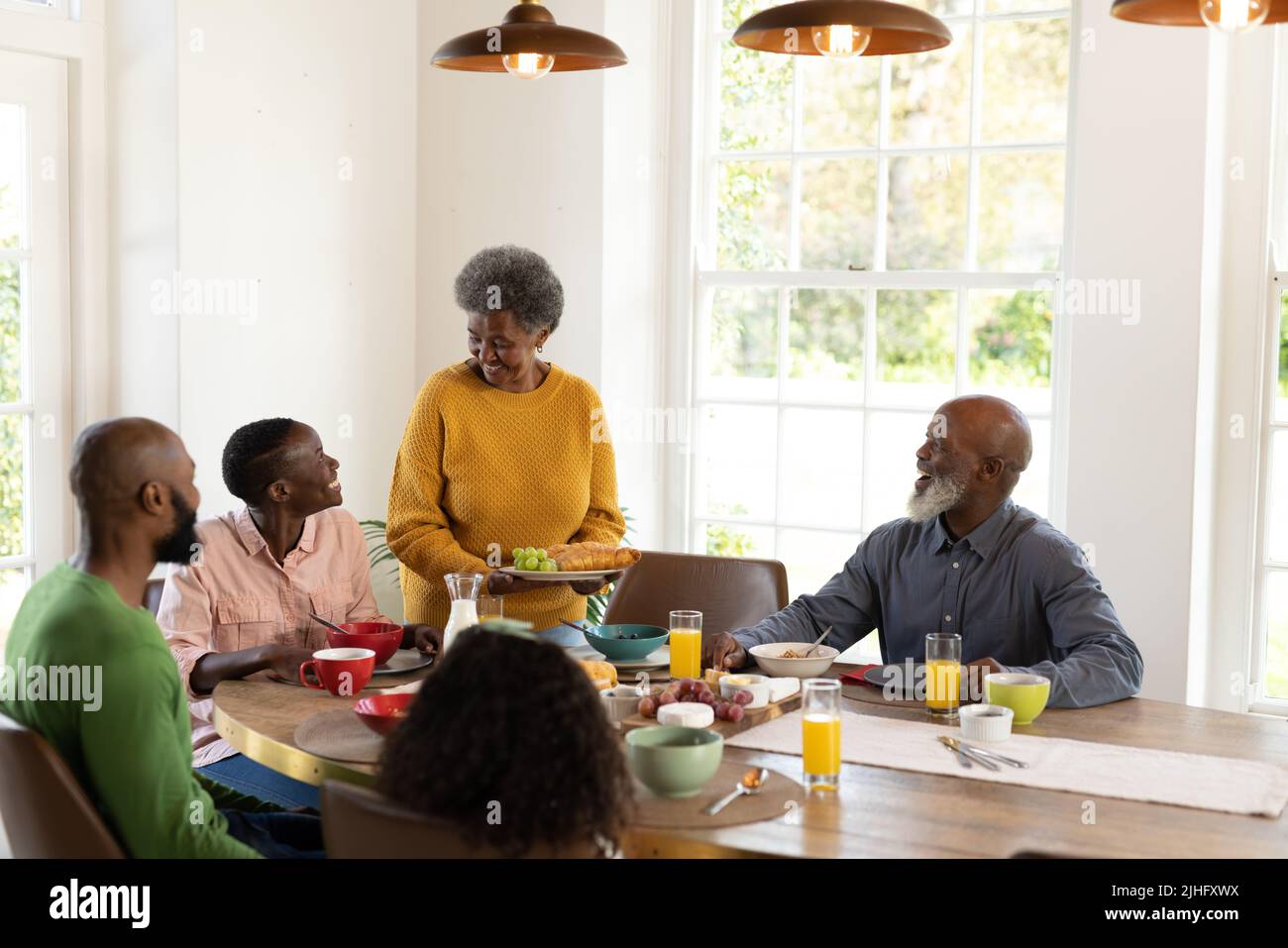 Image of happy multi generation african american family eating ...