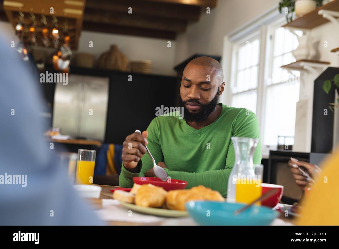 Image of african american man eating breakfast with family Stock Photo ...