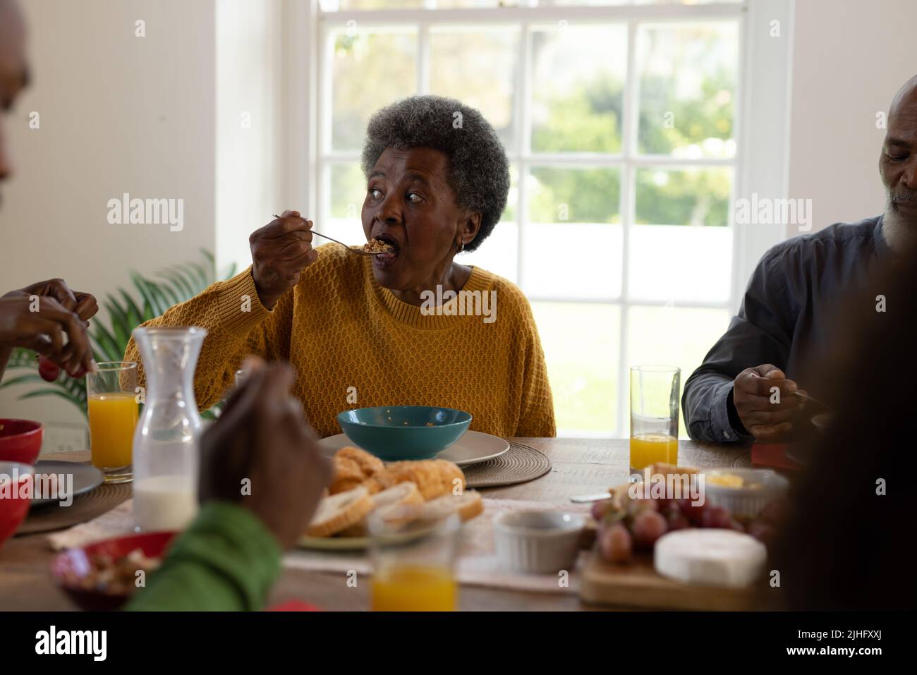 Image of happy multi generation african american family eating breakfast Stock Photo - Alamy