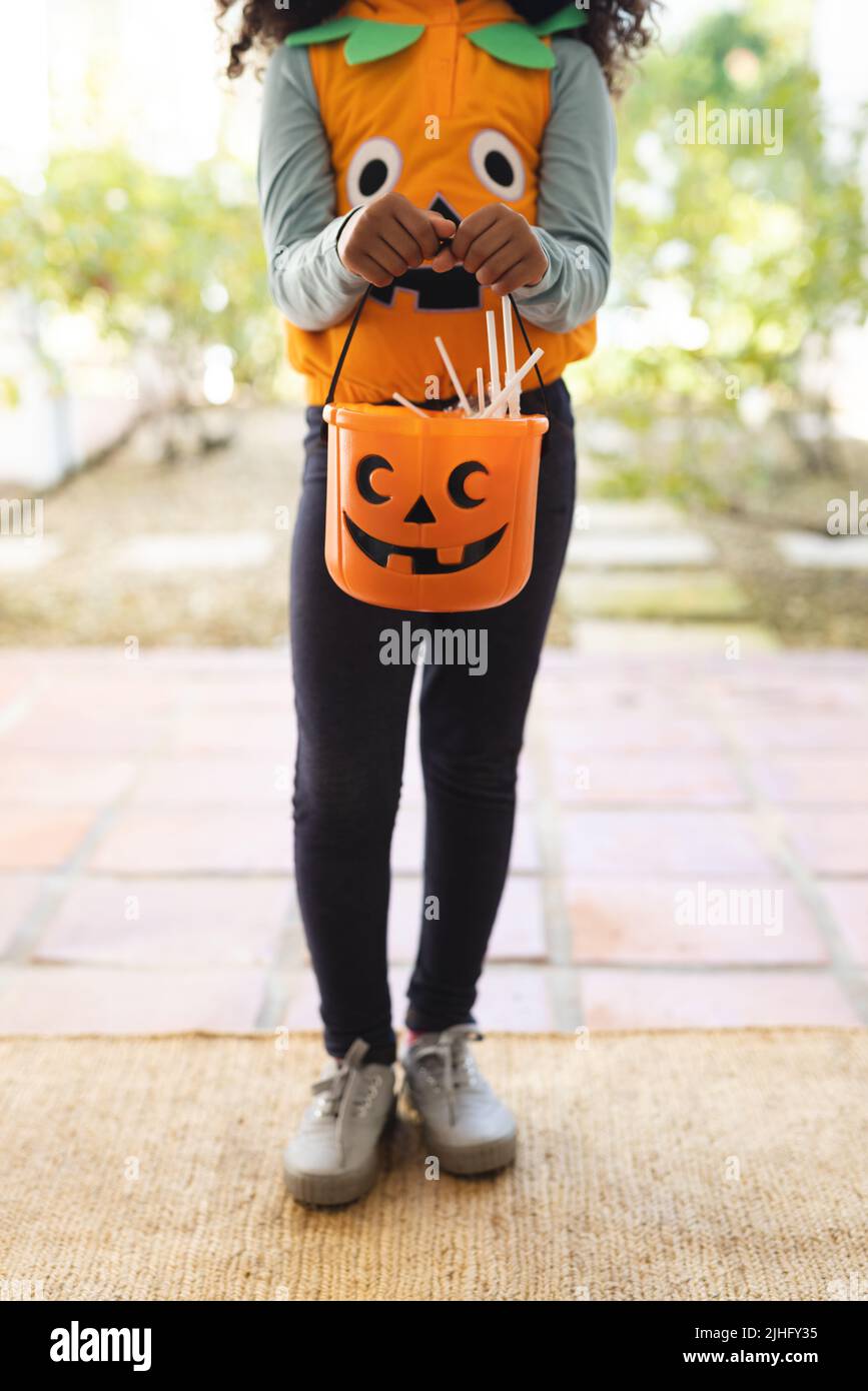 Vertical image of midsection of african american girl in halloween ...