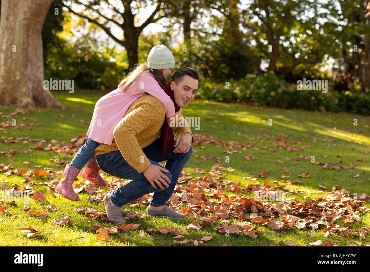Image of happy caucasian father and daughter having fun in autumn ...