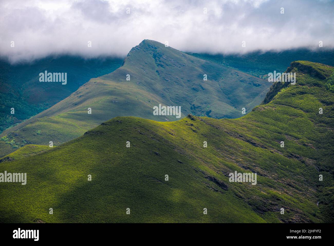 The highest peaks of the Courel range brush the belly of a layer of ...