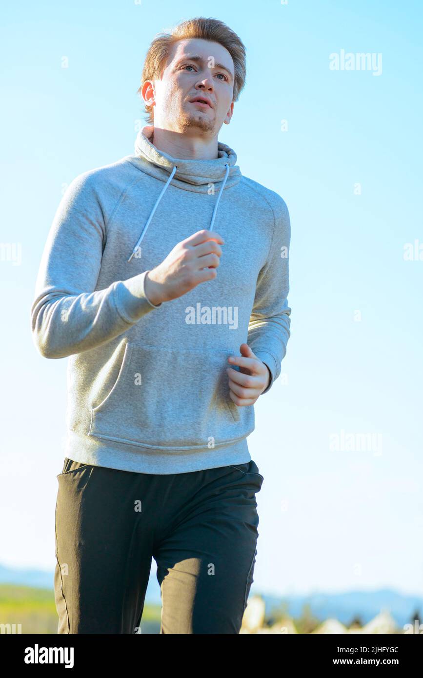 Running man jogging in rural nature at beautiful summer day. Sport ...