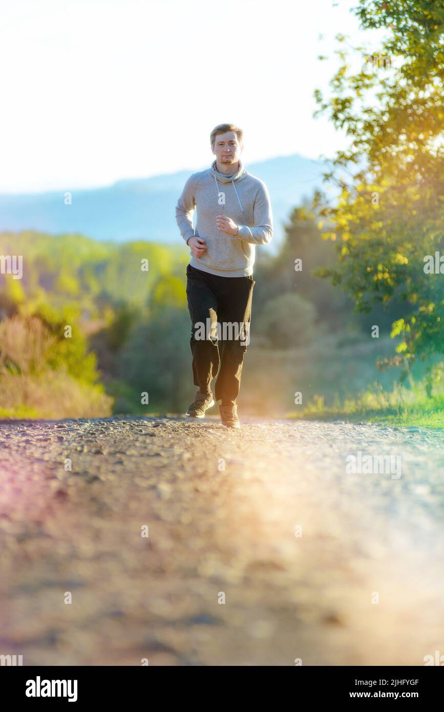 Running man jogging in rural nature at beautiful summer day. Sport ...