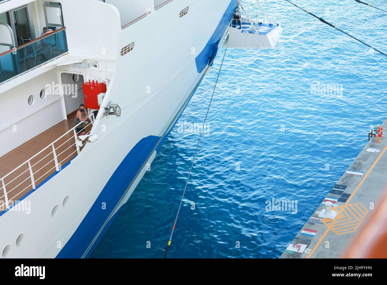 Ship's officer standing on the mooring plaform to oversee the safety of ...