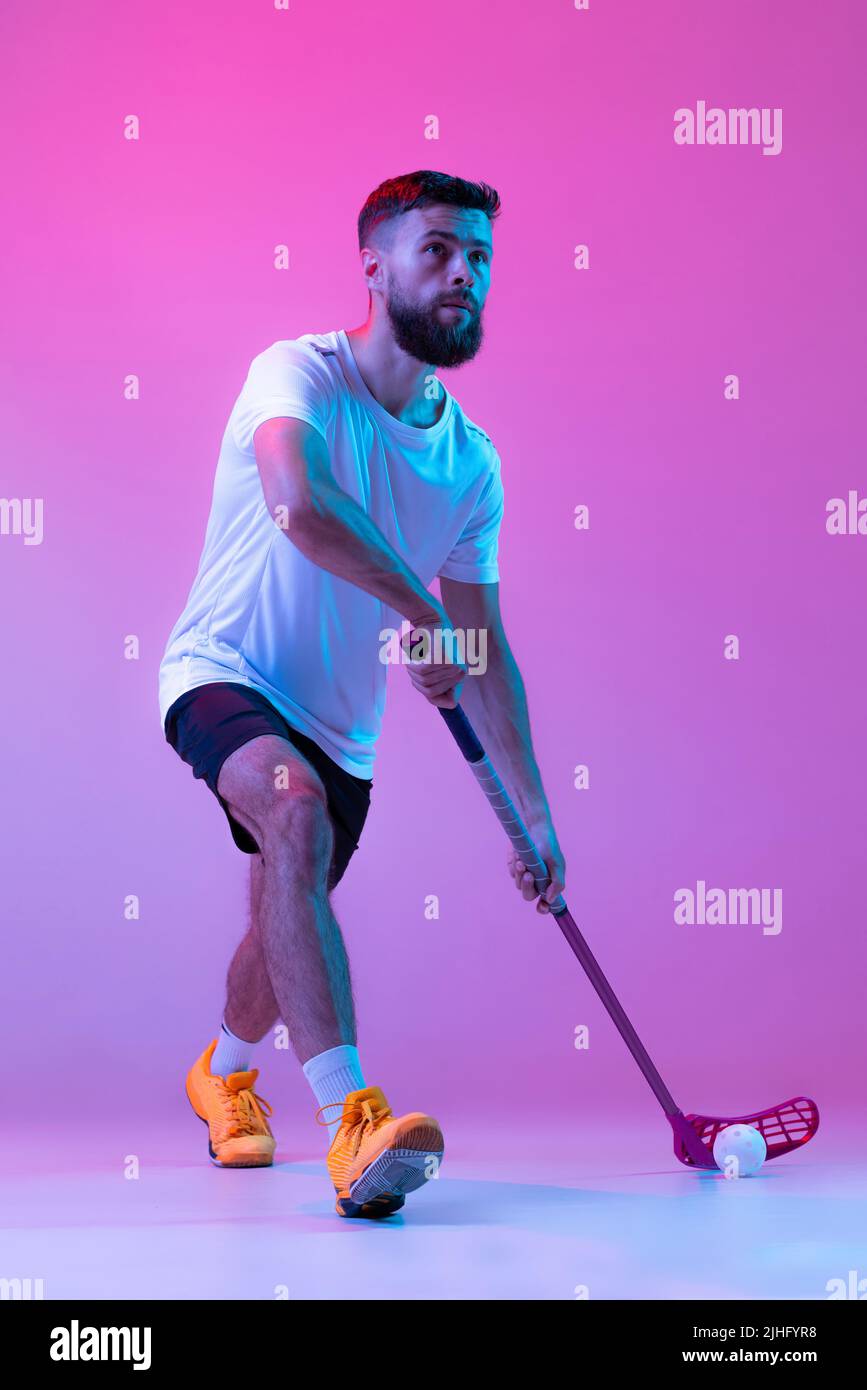 One sportive man, floorball player with floorball stick training ...
