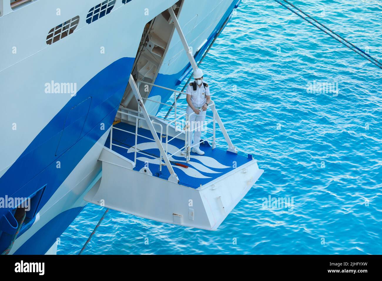 Ship's officer standing on the mooring plaform to oversee the safety of ...