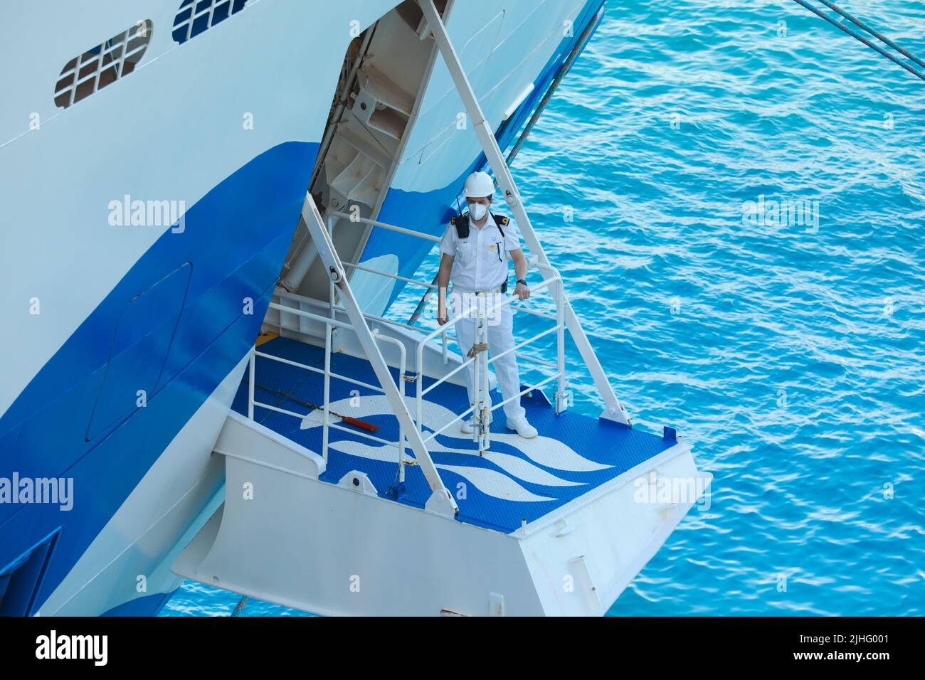 Ship's officer standing on the mooring plaform to oversee the safety of ...