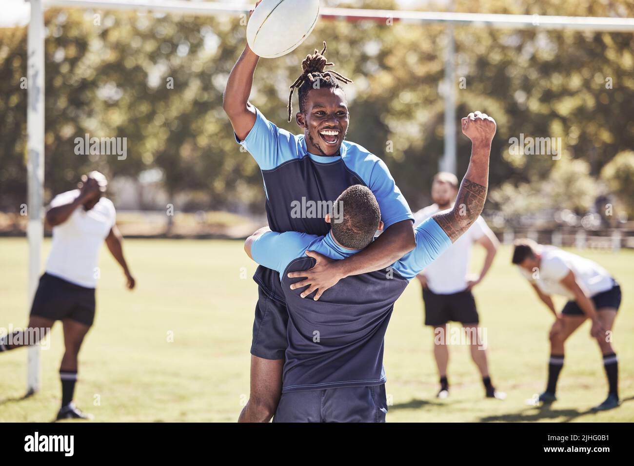 Diverse rugby teammates celebrating scoring a try or winning a match ...